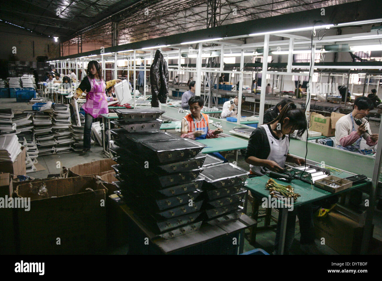 Workers works at a assembly line in Chuan Ying Electric Appliance Co ...