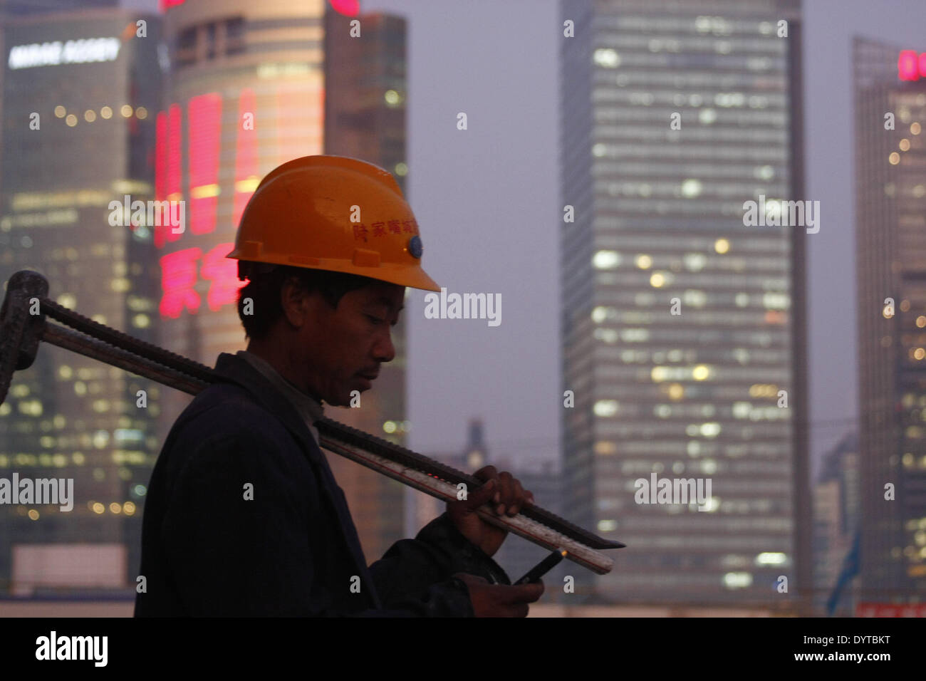 A worker uses his cell phone at the Bund in Shanghai on 23 Nov 09 Stock ...