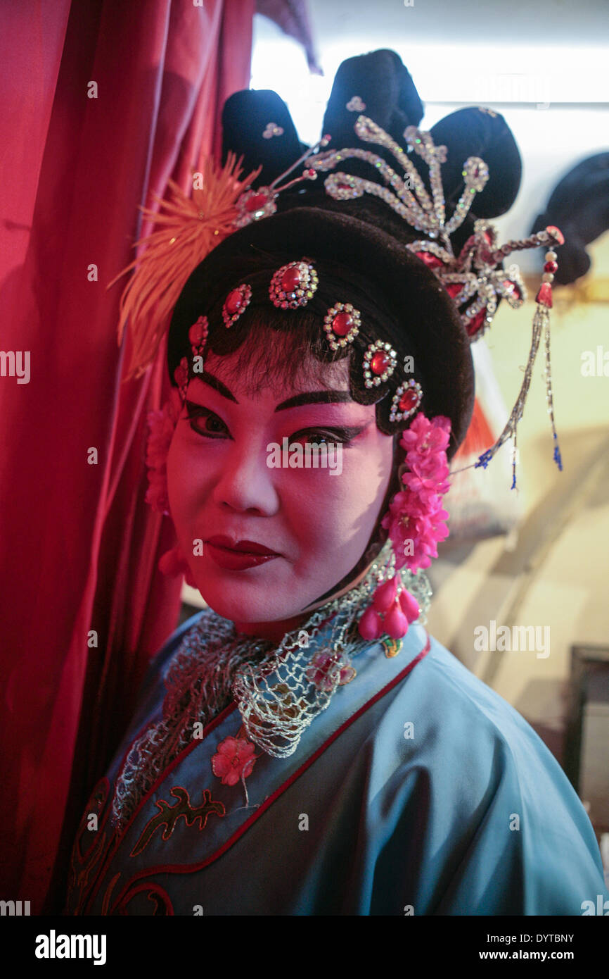 Chinese traditional opera artists pose for a picture before their daily ...