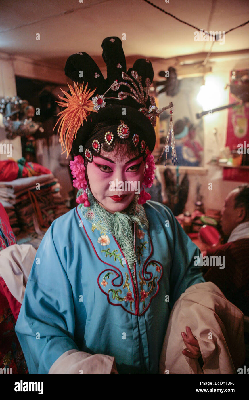 Chinese traditional opera artists pose for a picture before their daily ...