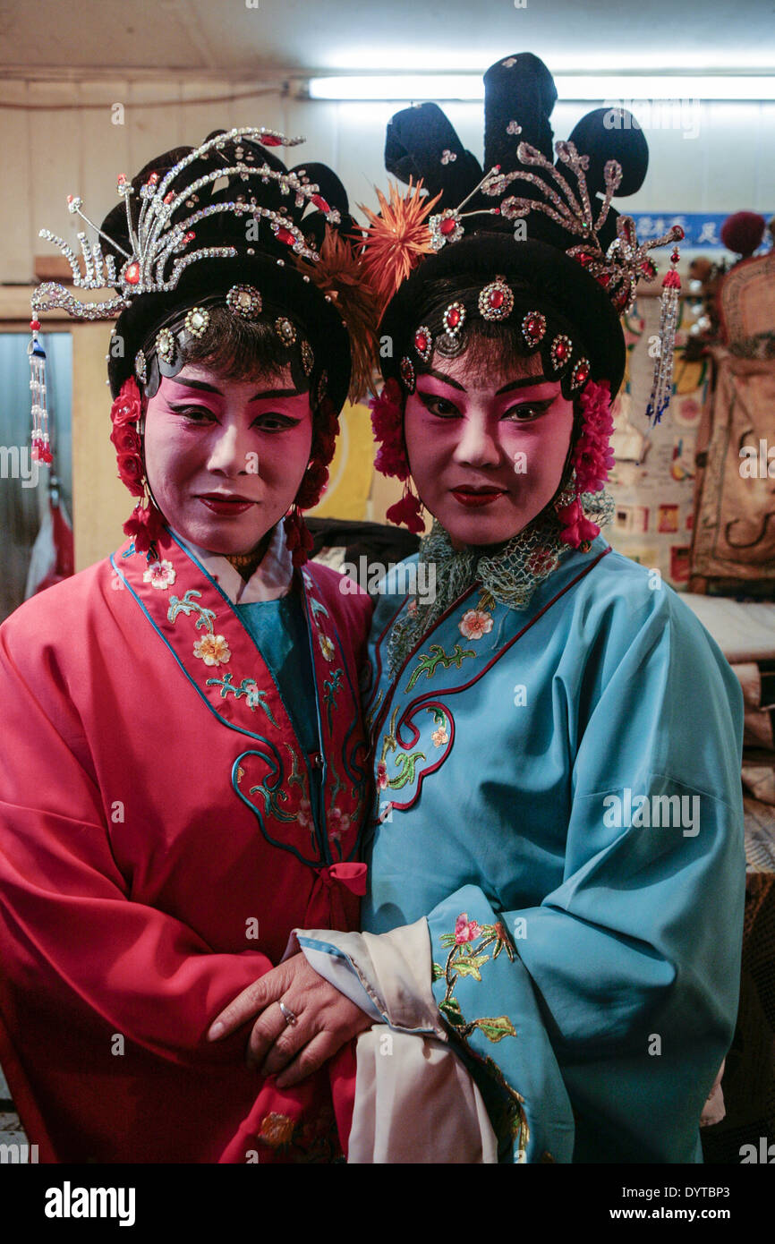 Chinese traditional opera artists pose for a picture before their daily ...