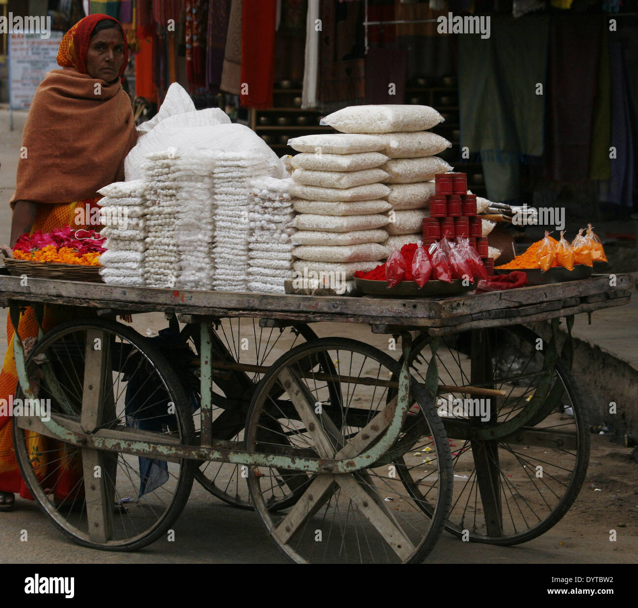 Woman push cart loaded with color dye used in festivals hi-res stock ...
