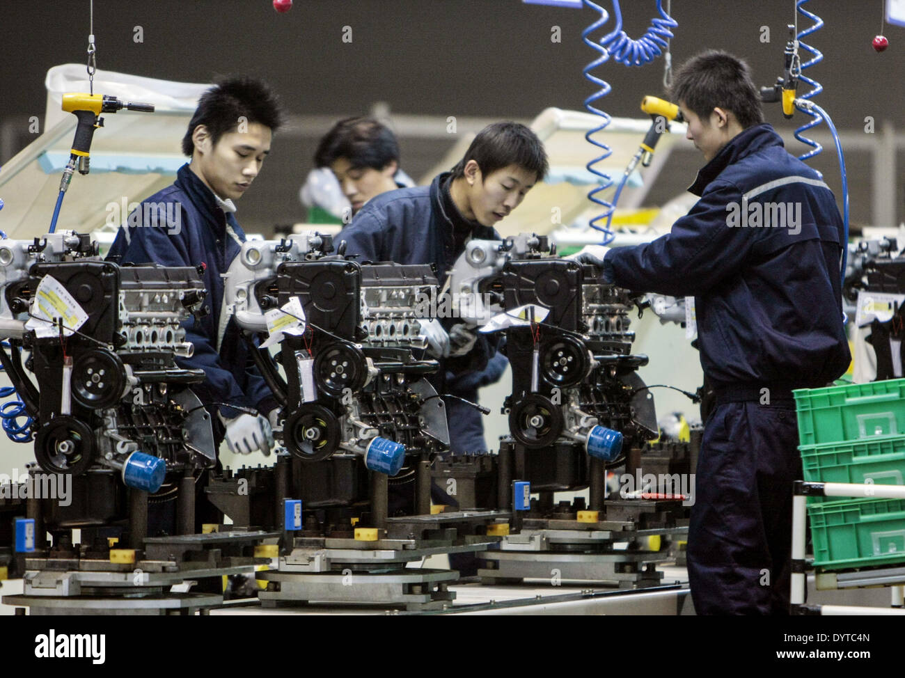 Workers assemble engines at a production line of KIA Motor's Cerato at ...