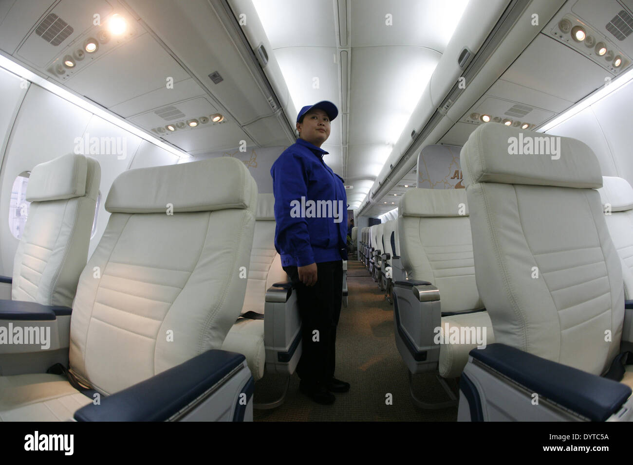 A Chinese worker stands inside a ARJ 21 commercial aircraft model at a ...