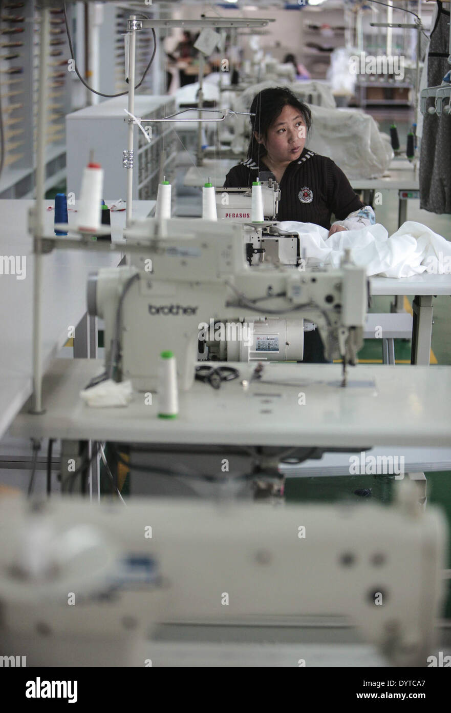 A worker works at a half full workshop at Ever-Glory International ...