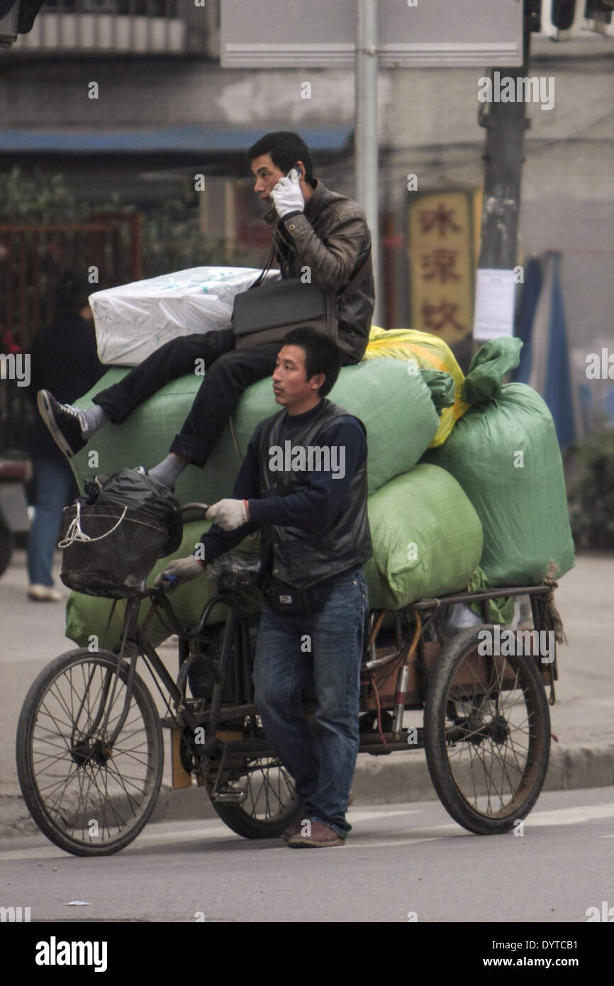 A man sit on bags of goods Stock Photo - Alamy