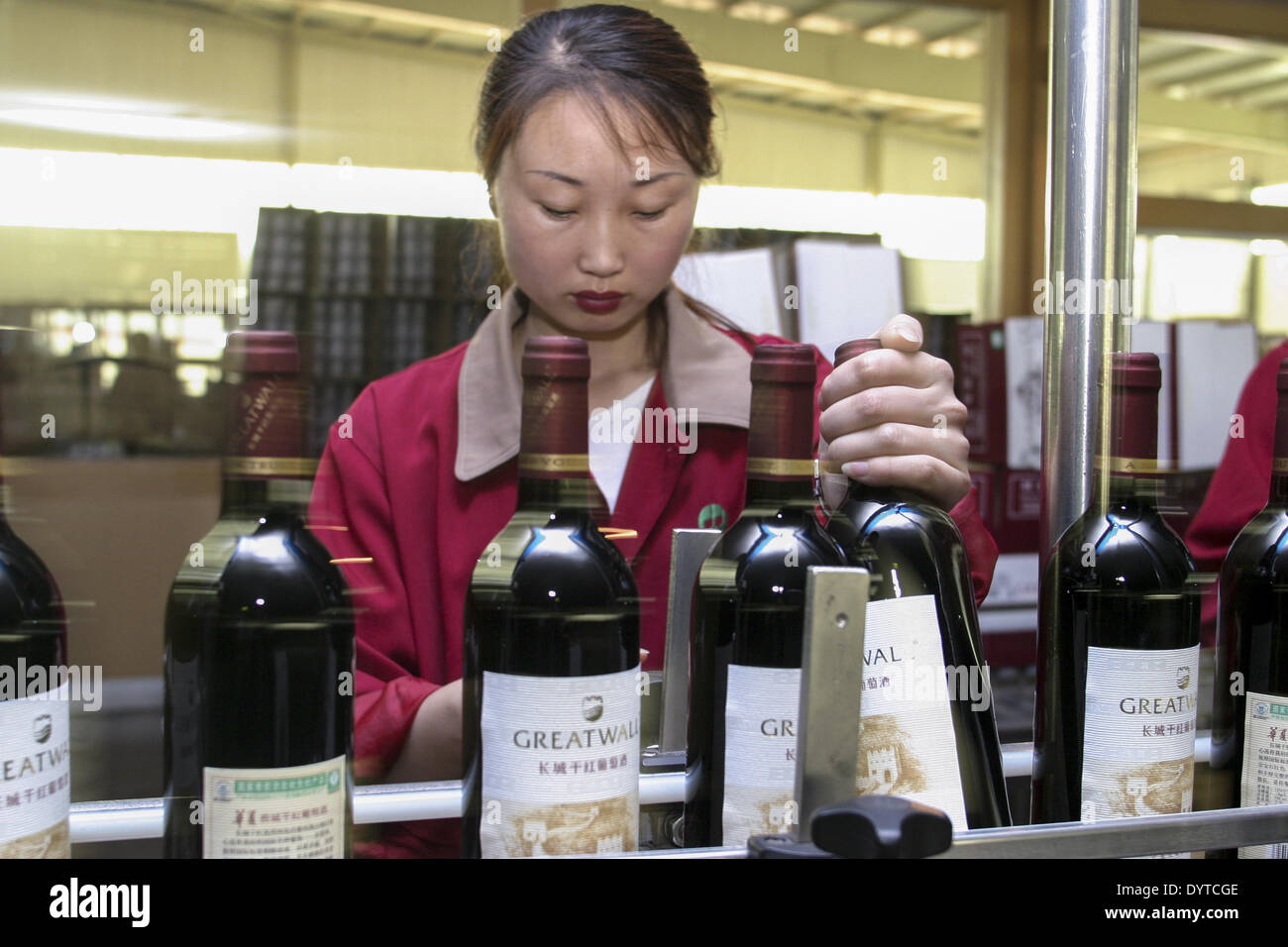 Workers put bottles of Great Wall red wine into boxes at the Huaxia ...
