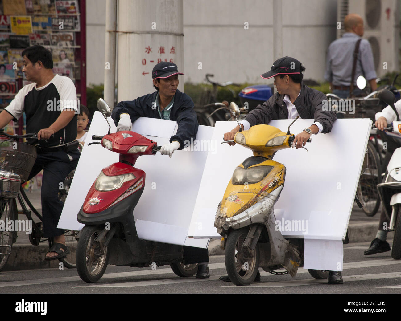 Two workers on motorcycle chat in front of red light Stock Photo - Alamy