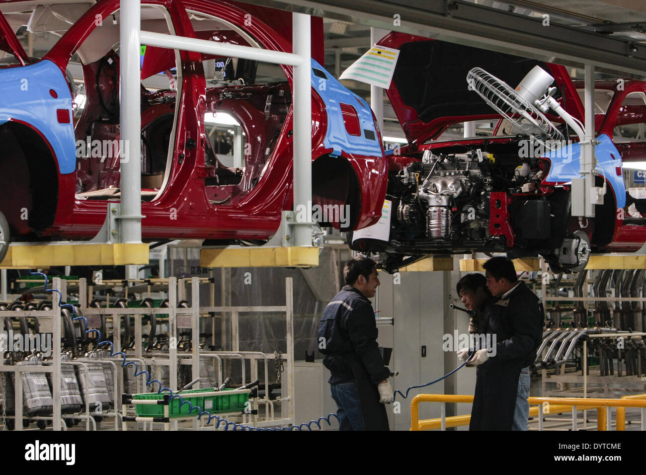 Workers assemble a vehicle on the production line of Kia Motors Corp ...