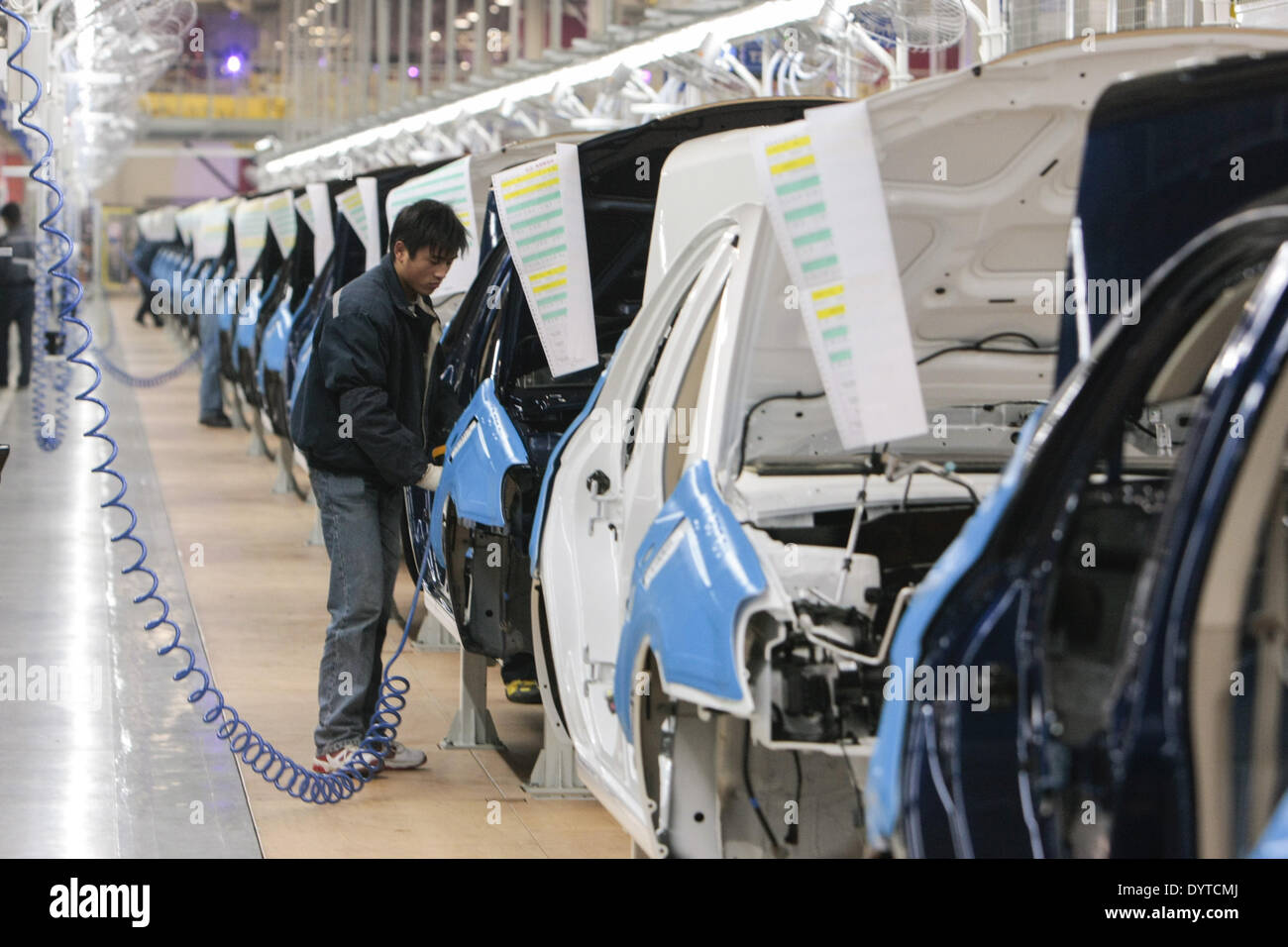 Workers assemble a vehicle on the production line of Kia Motors Corp ...