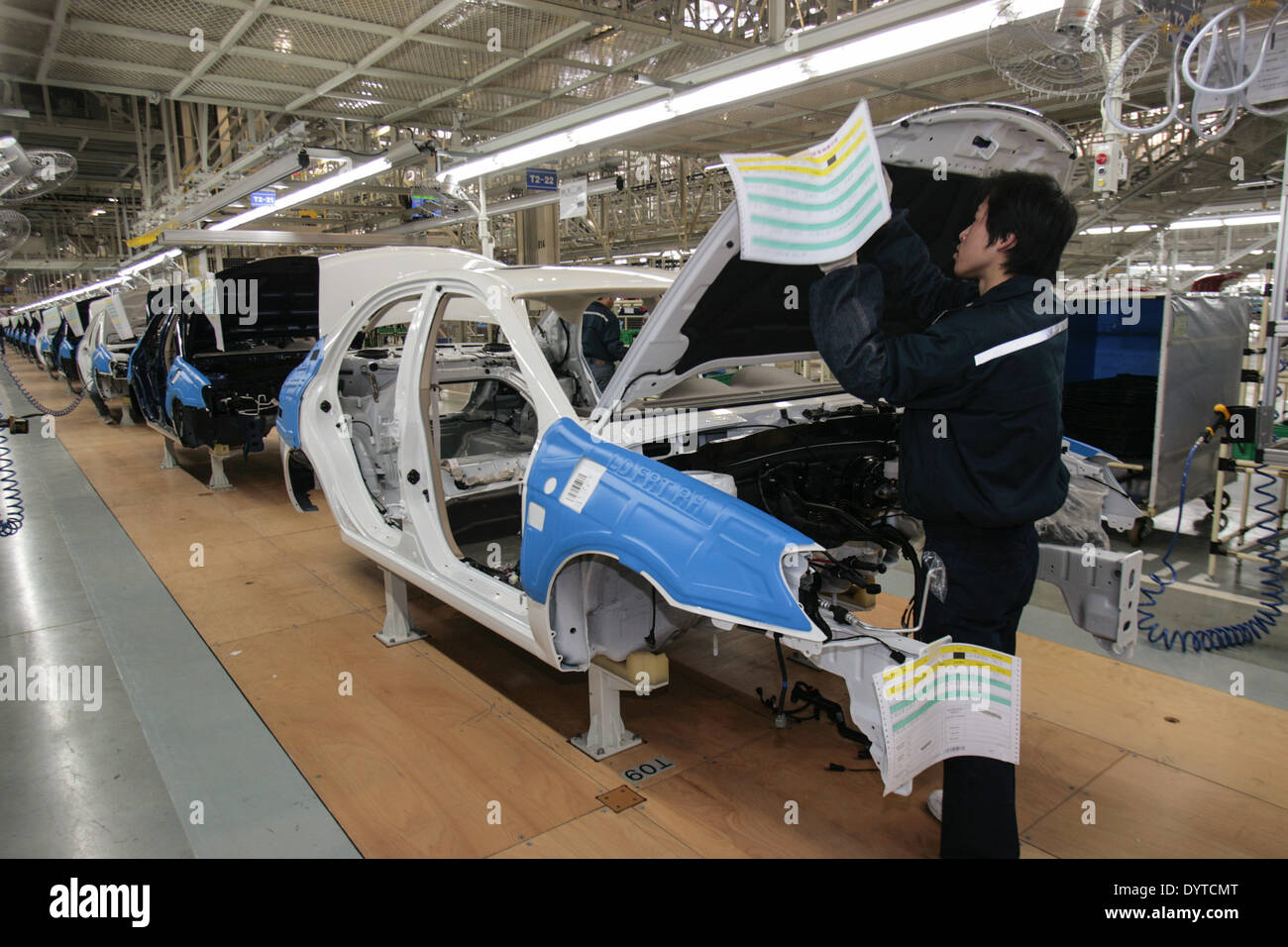 Workers assemble a vehicle on the production line of Kia Motors Corp ...
