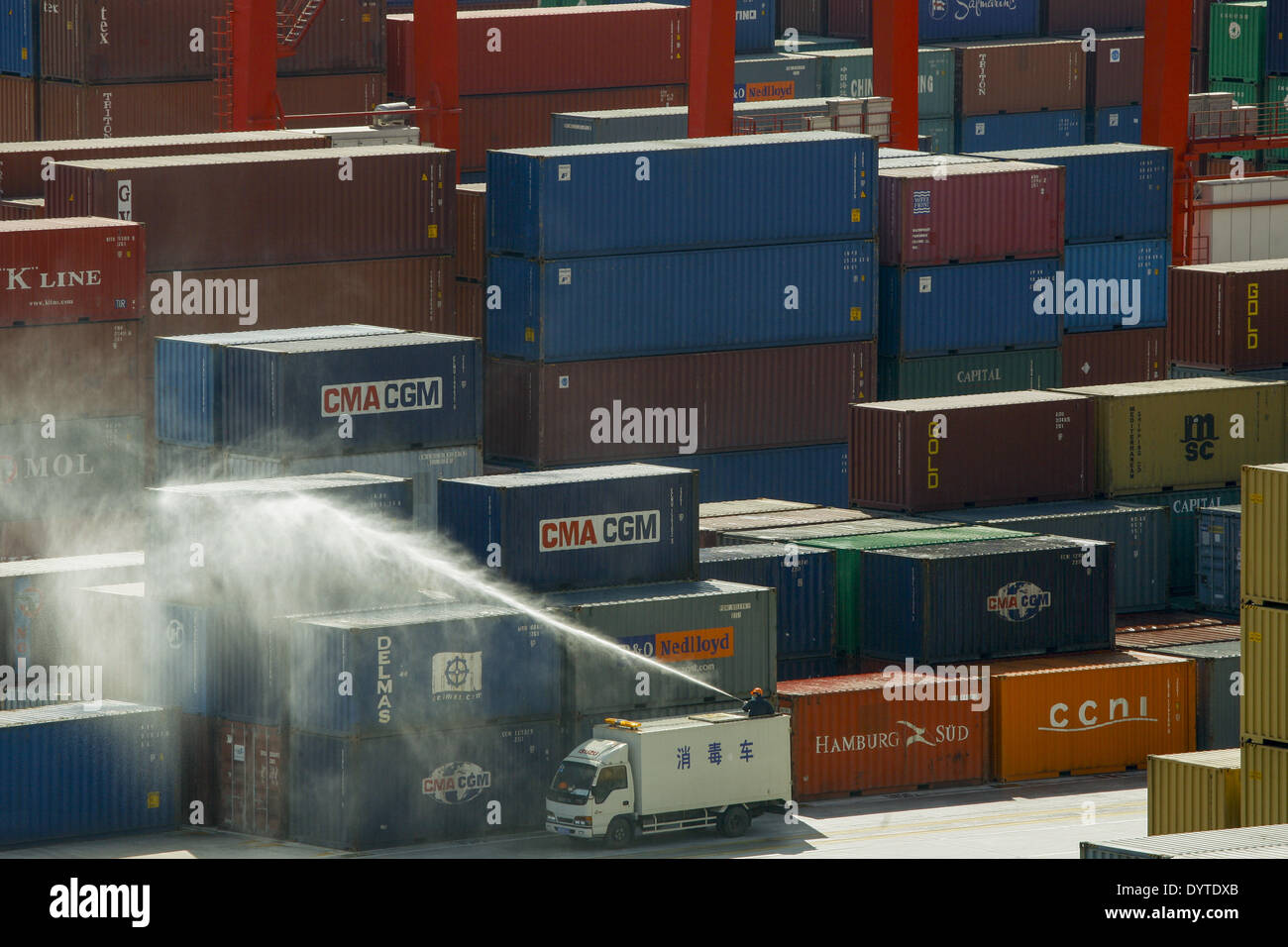 Workers spray disinfectant to containers at Yangshan Deep Water Port ...