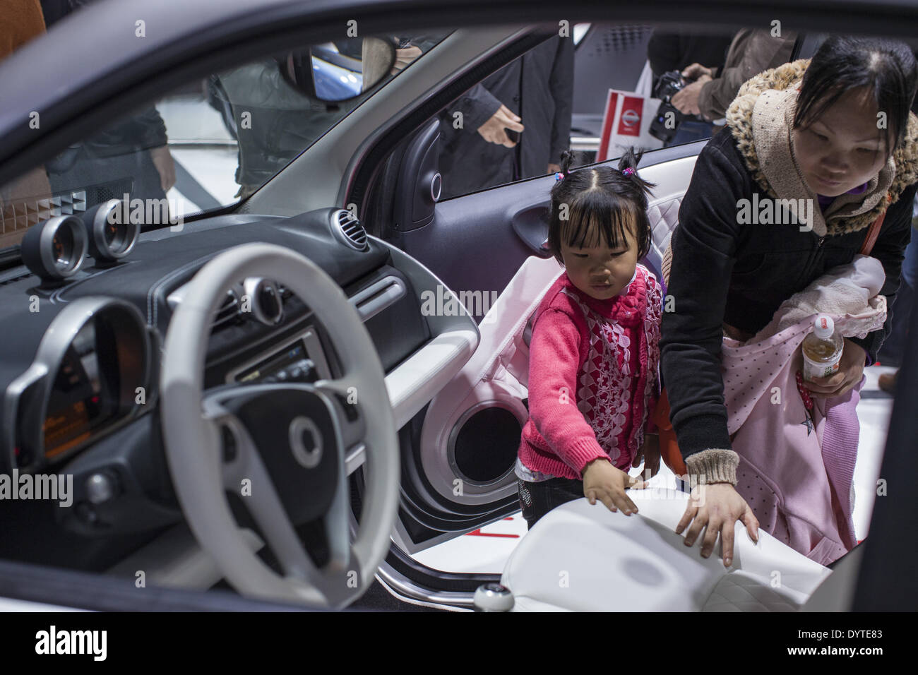 A mother and her daughter feel the seat of a Mercedes-Benz Smart's ...