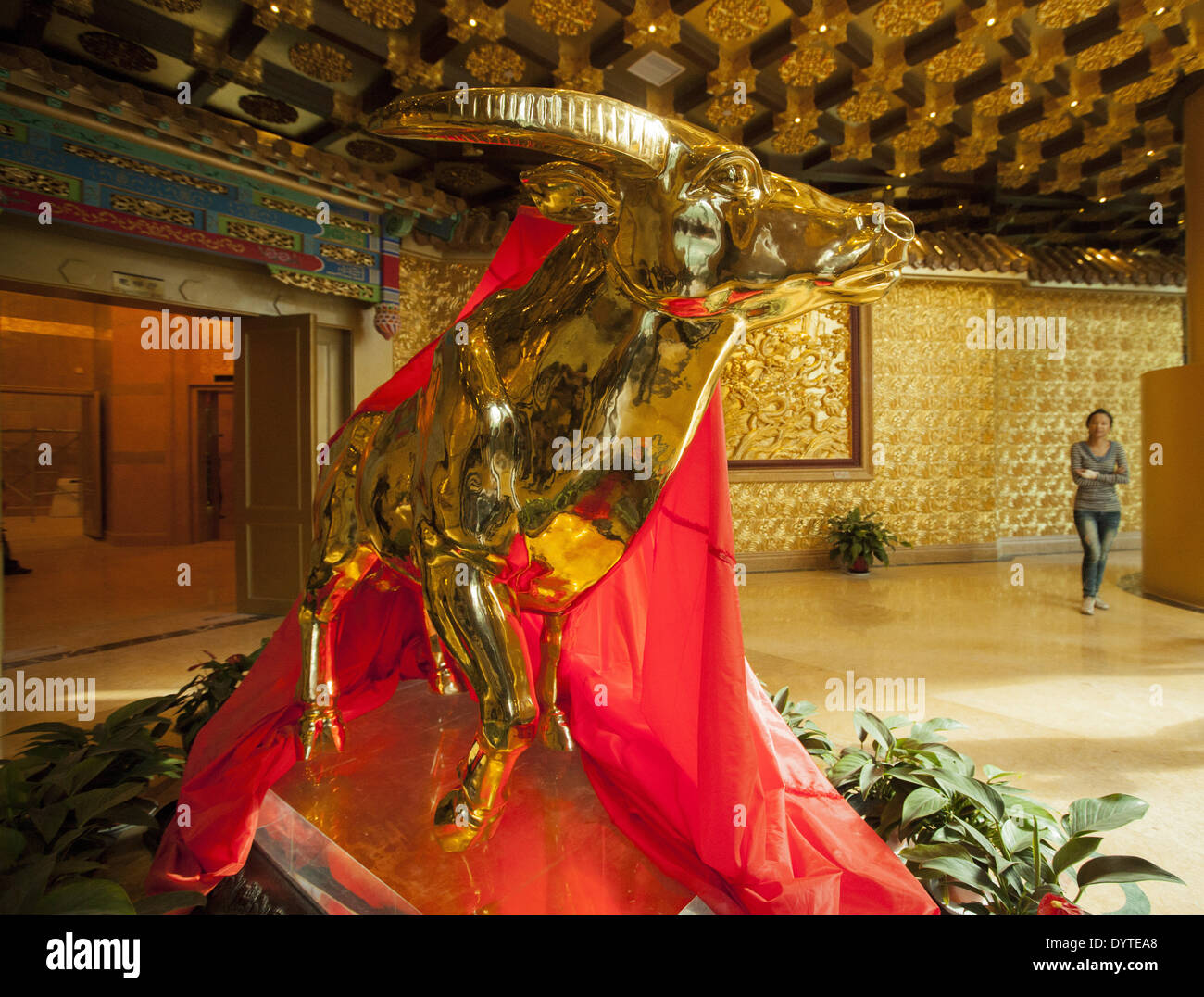 A one-ton solid-gold water buffalo stands inside the 328 meter tall ...