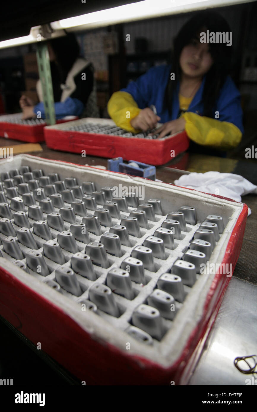 Workers make lighters at a factory Stock Photo - Alamy