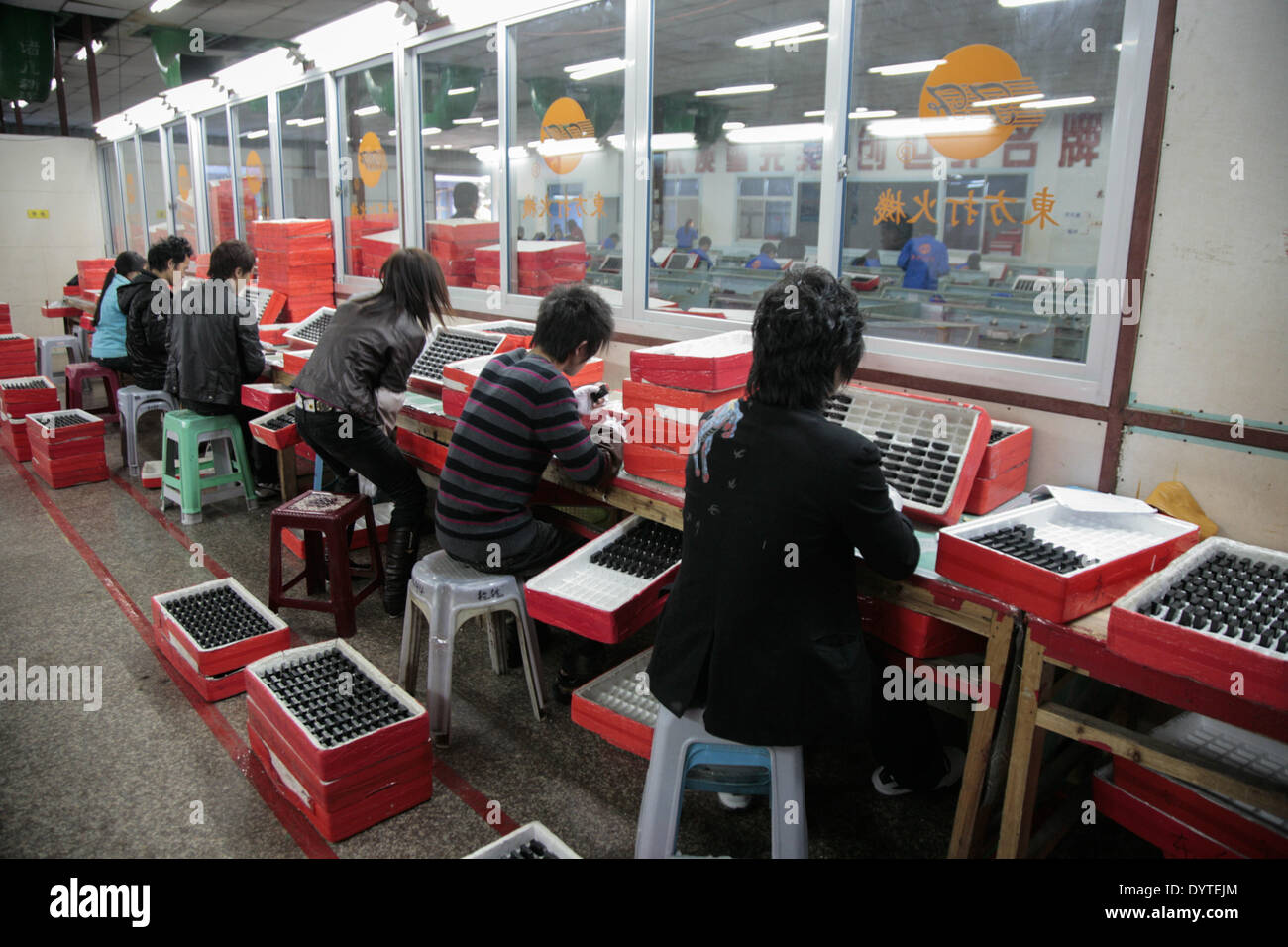 Workers make lighters at a factory Stock Photo - Alamy