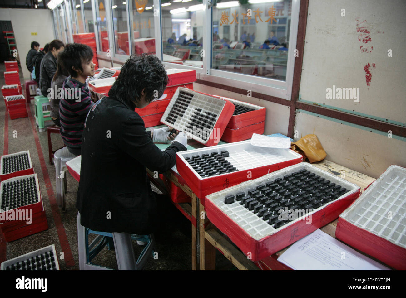 Workers make lighters at a factory Stock Photo - Alamy