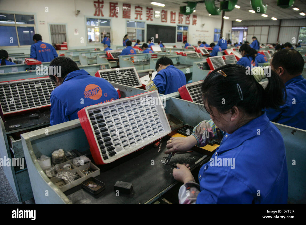 Workers make lighters at a factory Stock Photo - Alamy