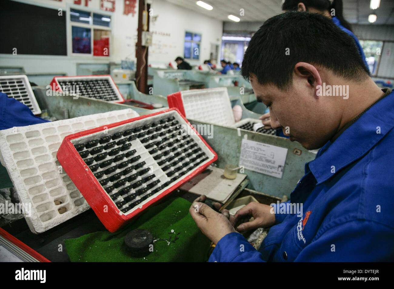 Workers make lighters at a factory Stock Photo - Alamy