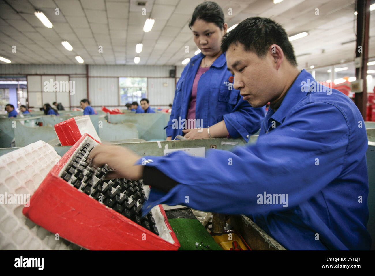Workers make lighters at a factory Stock Photo - Alamy