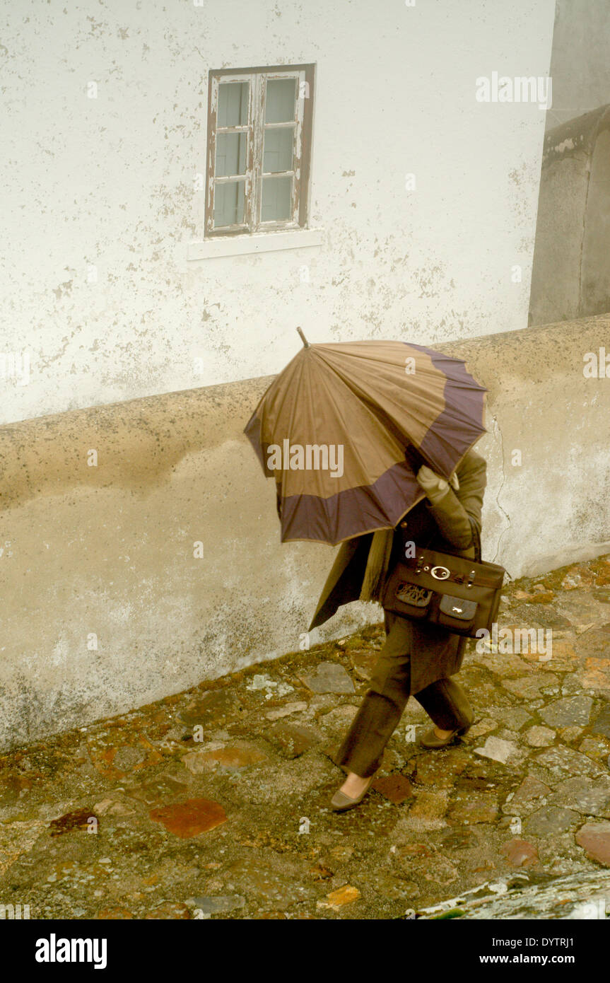 Women trying to walk on a rainy and windy day Stock Photo - Alamy