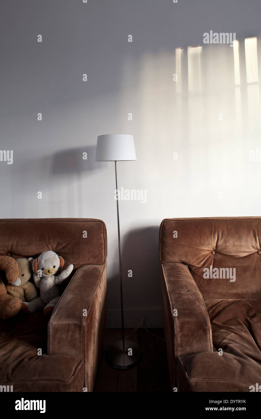 Two brown armchairs with floor lamp between, Whitechapel, London Stock ...