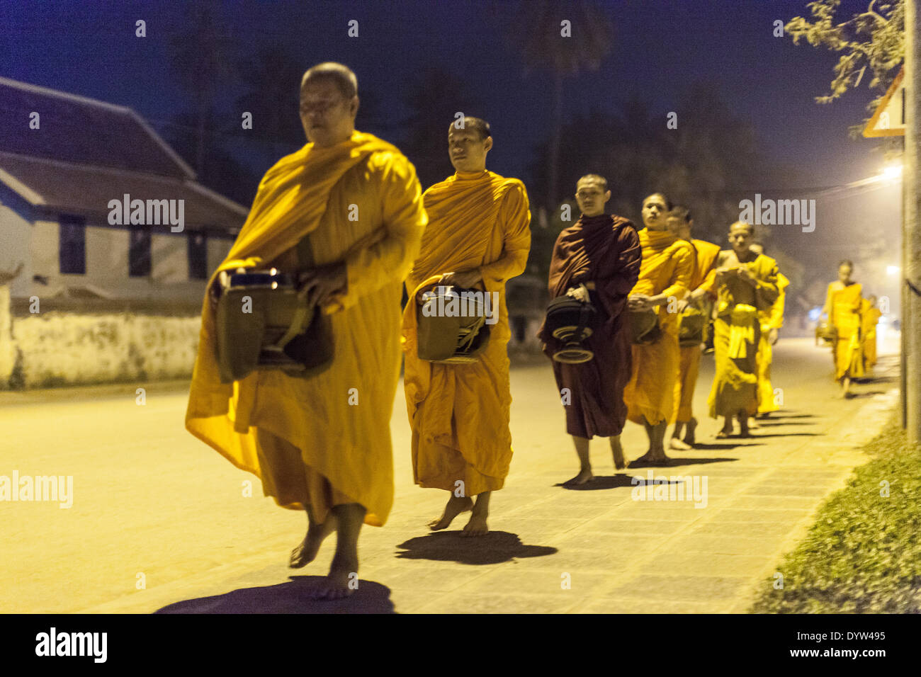 Monks walk in group to collect alms in early morning Stock Photo - Alamy