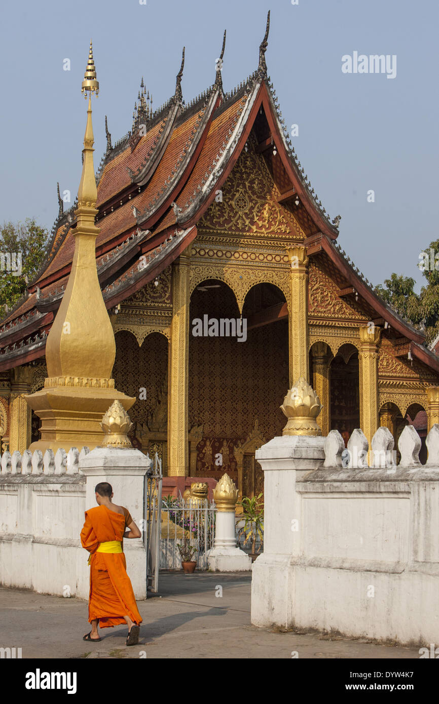 A monk walks in front of a temple Stock Photo - Alamy