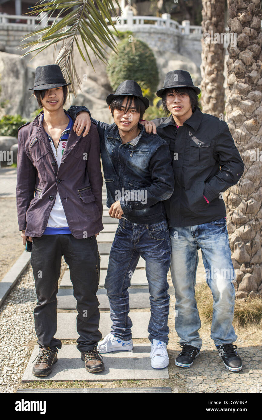 Three men pose for a picture Stock Photo - Alamy