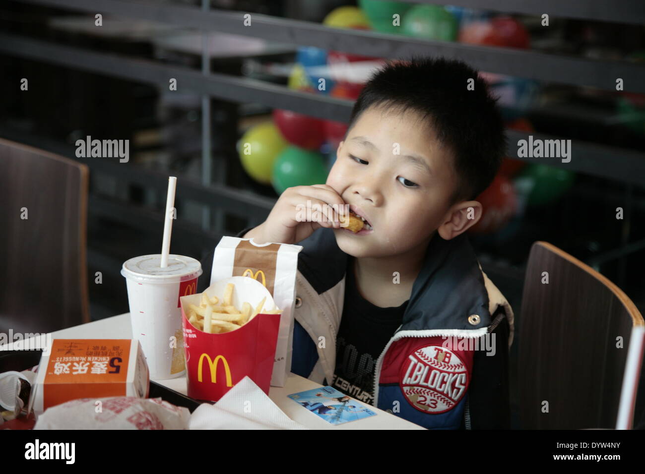 A kid eat in a Mcdonalds restaurant Stock Photo - Alamy