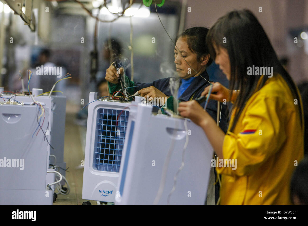 Workers works at a assembly line in Baoerma Electric Appliance Co Stock ...