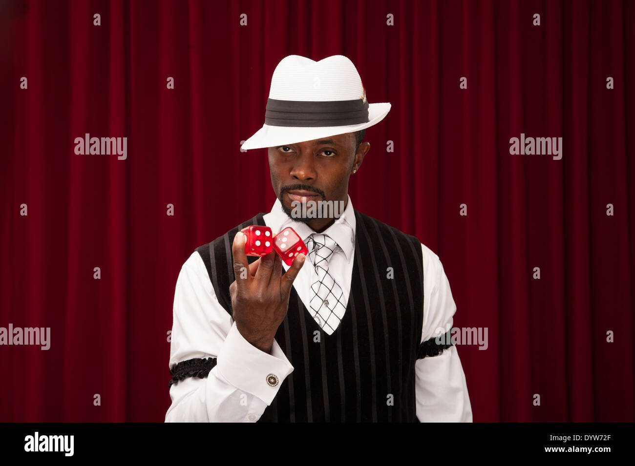 an african american gambler wears a retro suit and holds dice Stock ...