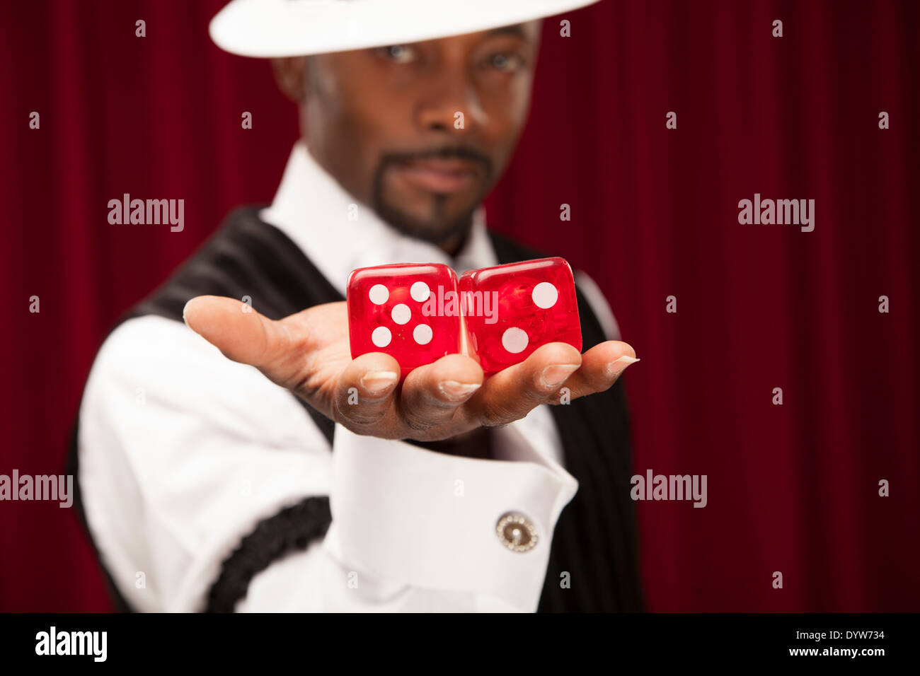 well dressed gambler in a retro suit holding over sized dice Stock ...