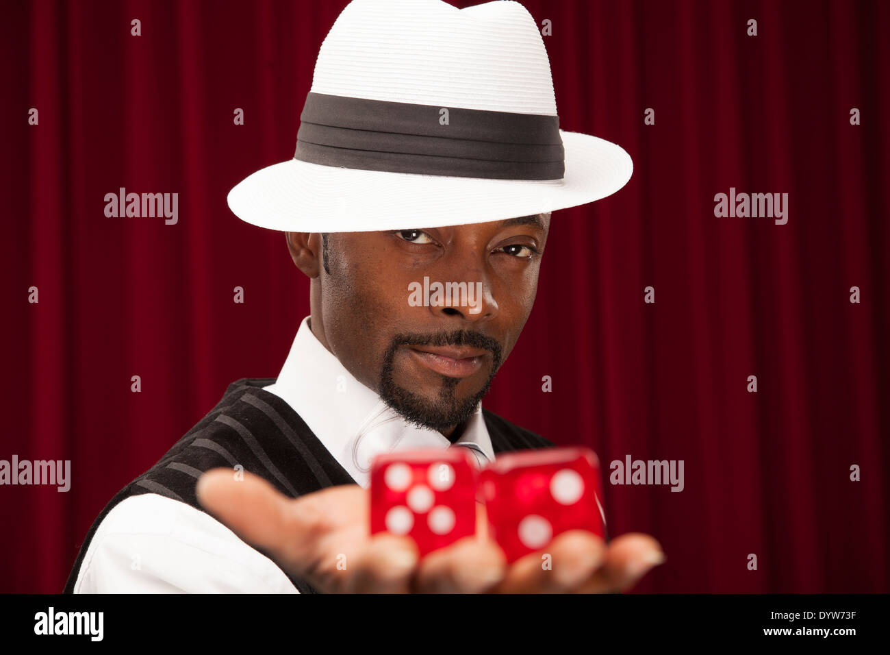 well dressed gambler in a retro suit holding over sized dice Stock ...