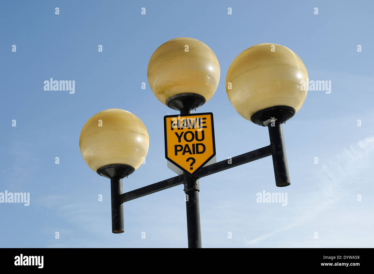 HAVE YOU PAID sign on lamp post Stock Photo - Alamy