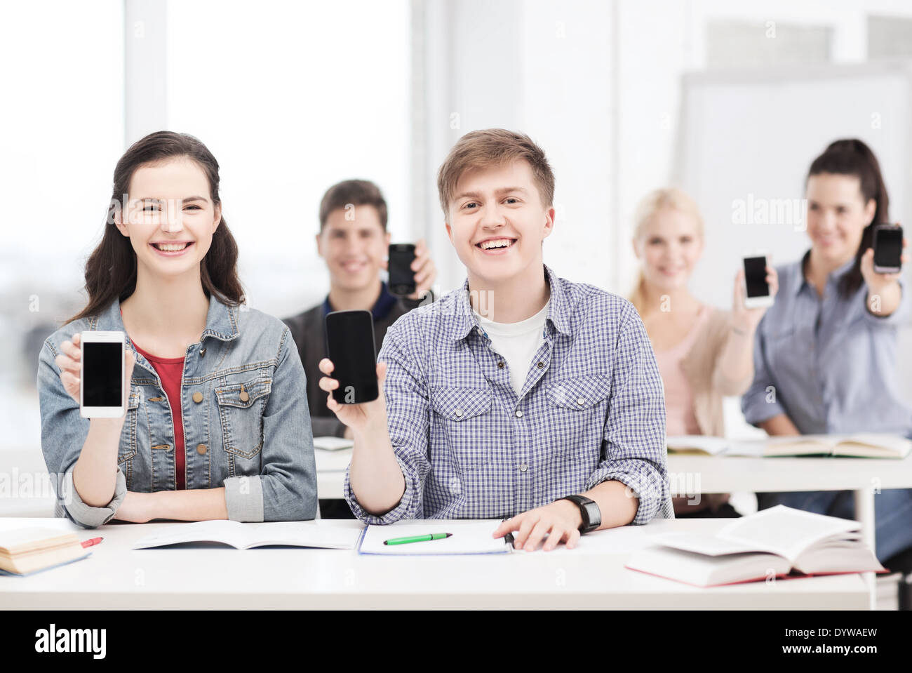 students showing black blank smartphone screens Stock Photo - Alamy