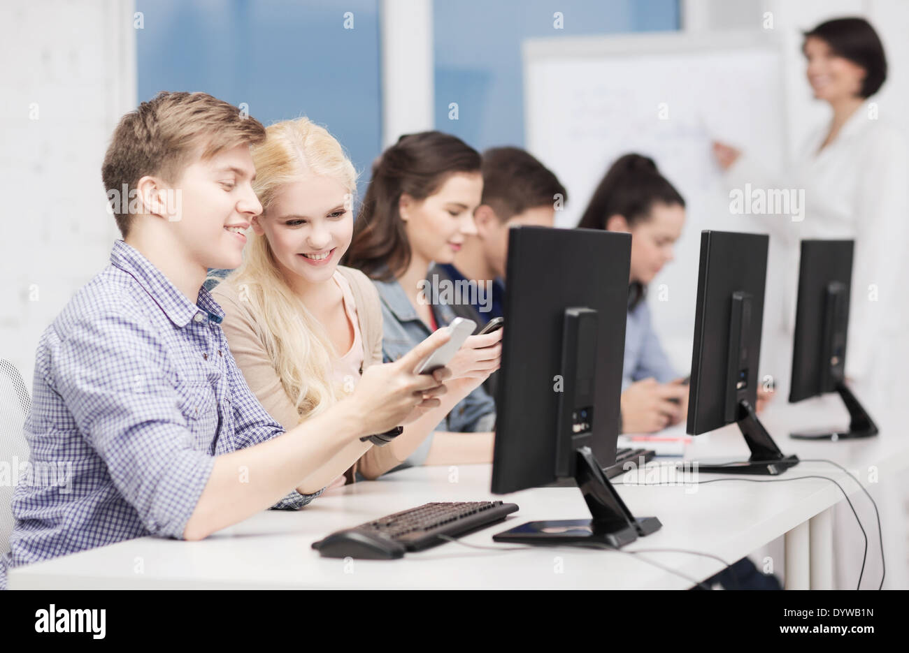 students with computer monitor and smartphones Stock Photo - Alamy