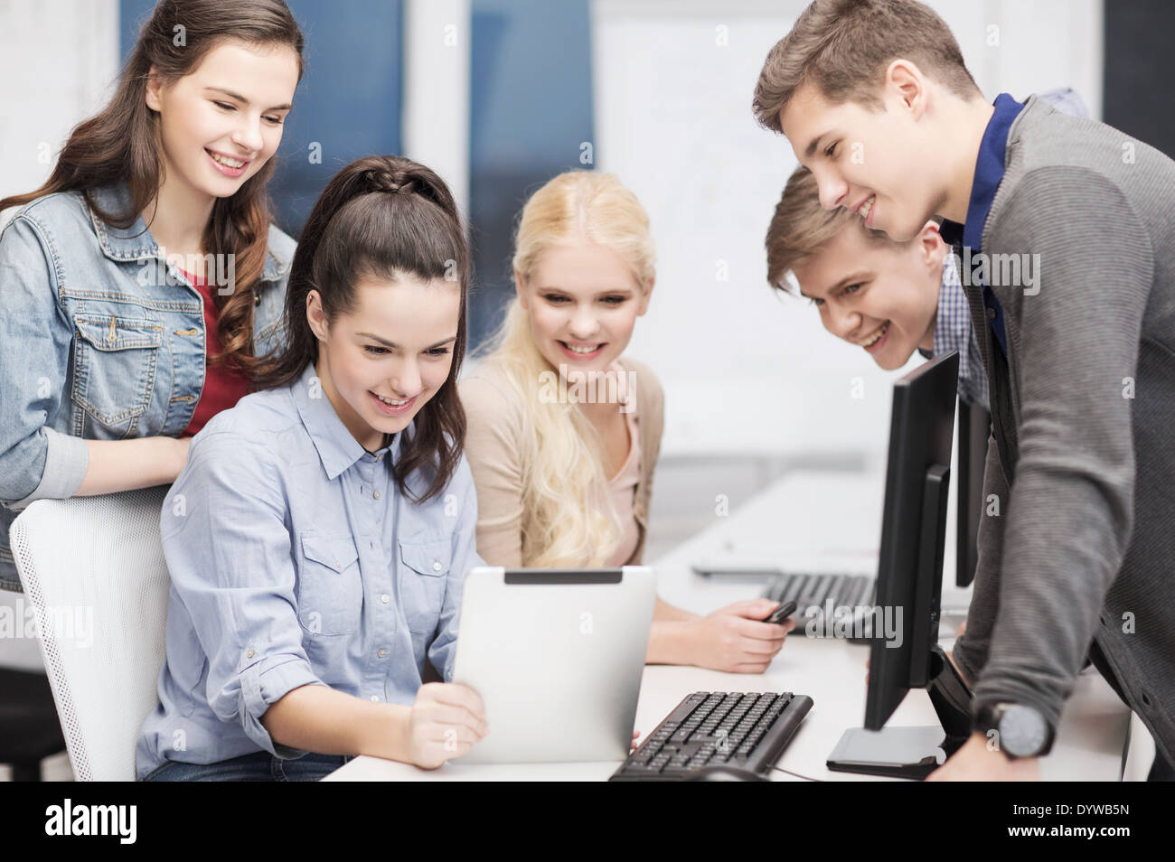 students with computer monitor and tablet pc Stock Photo - Alamy