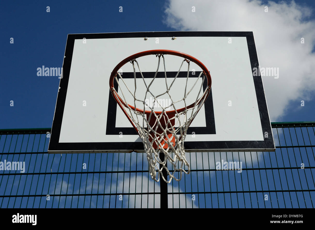Basketball net against fence and blue sky Stock Photo - Alamy
