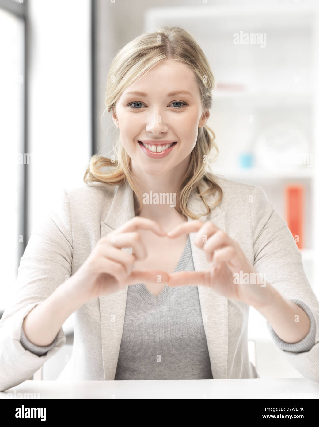 young woman showing heart sign Stock Photo - Alamy