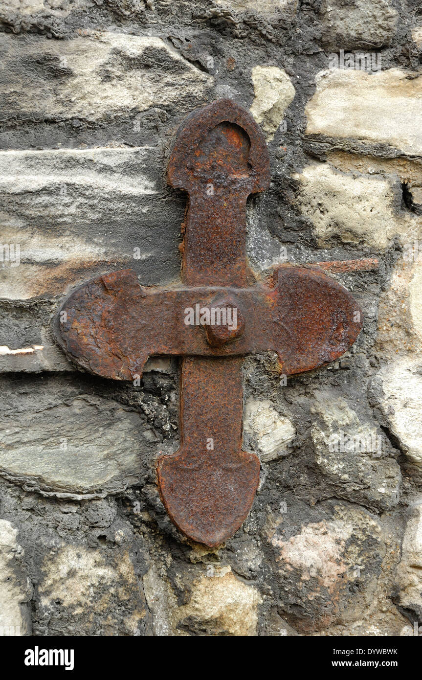 Medieval iron cross pinning of stone wall Stock Photo - Alamy