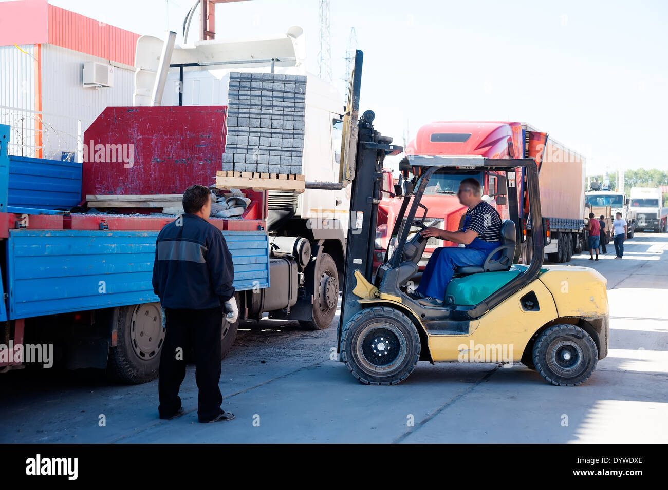 Loading sidewalk products in truck Stock Photo - Alamy