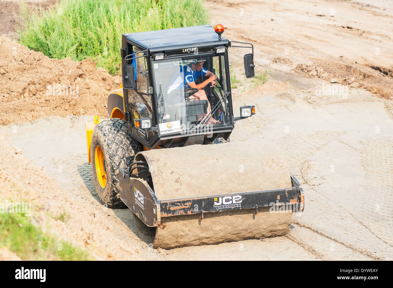 Road roller compressing sand to highway Stock Photo - Alamy