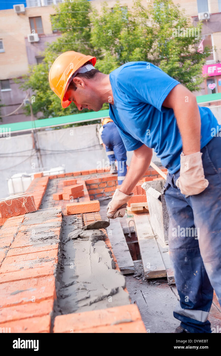 Bricklayer on house construction Stock Photo - Alamy