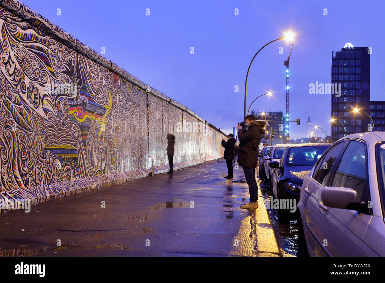 Berlin, Germany, tourists take photos at night at the East Side Gallery ...