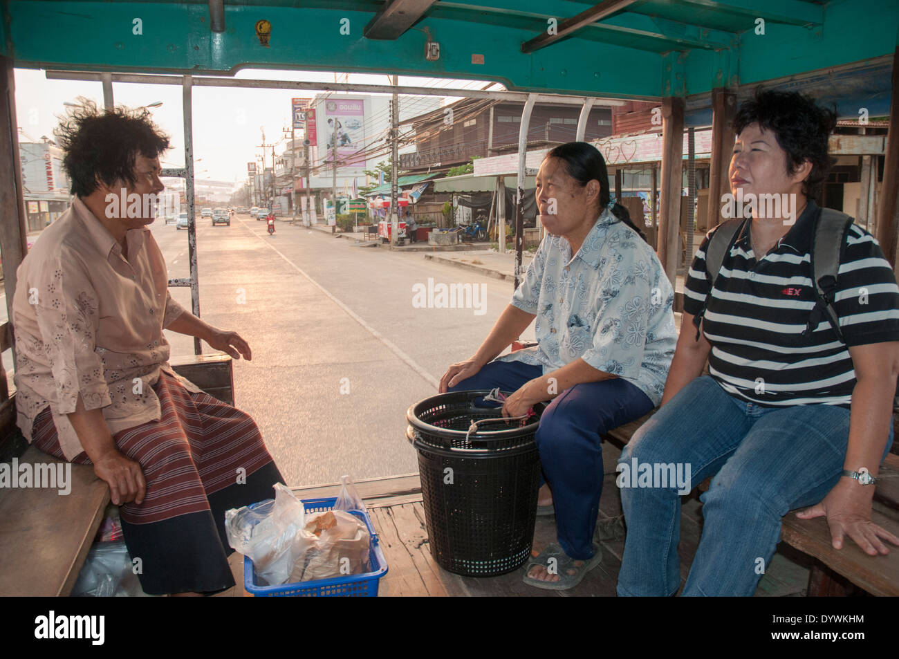 Riders aboard an old-fashioned songthaew truck in Sukhothai, Thailand ...