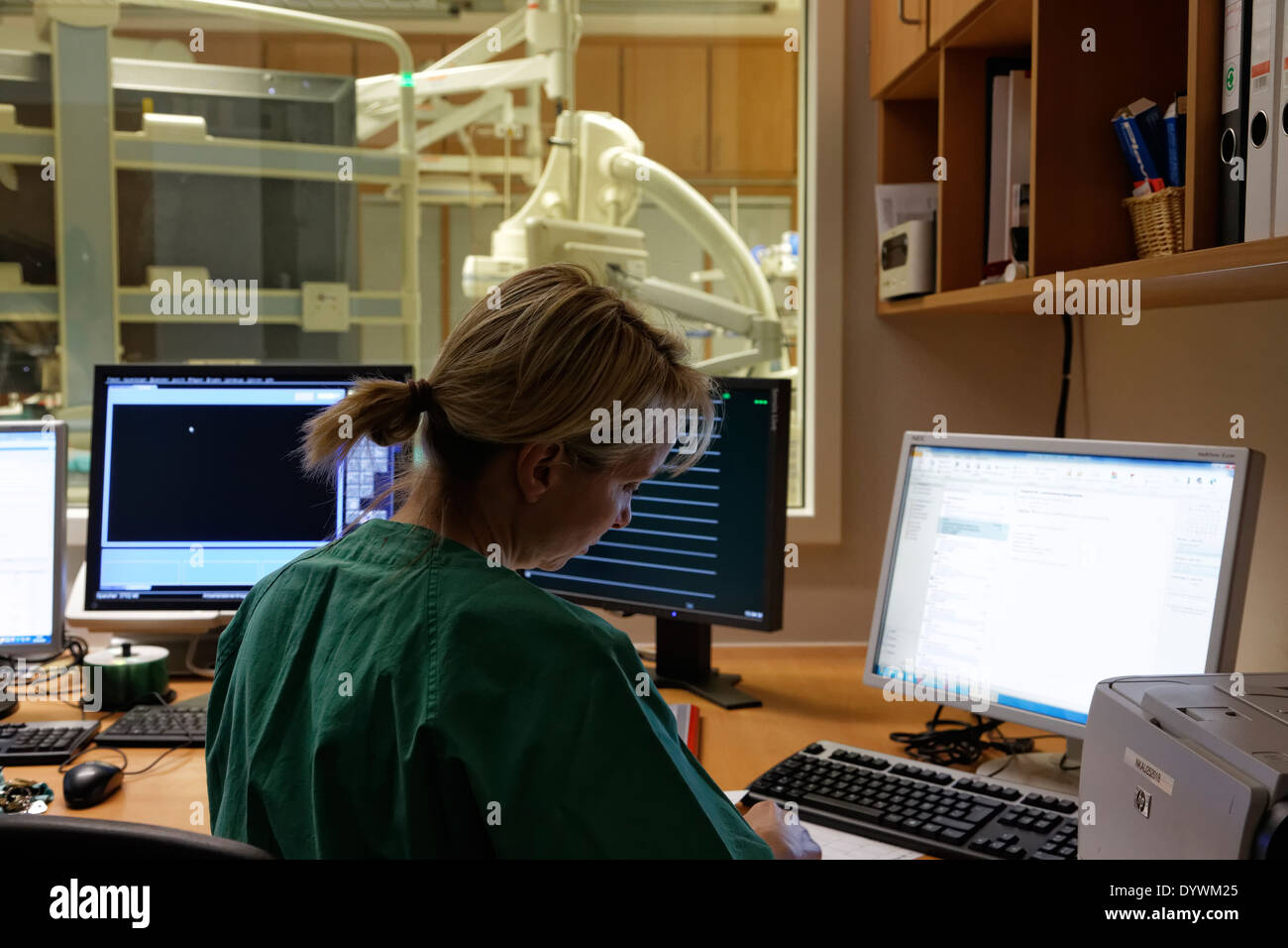 Berlin, Germany, surgical nurse in front of screens in the hybrid OR of ...