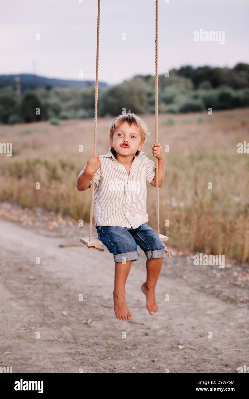 Child swinging tree hi-res stock photography and images - Alamy
