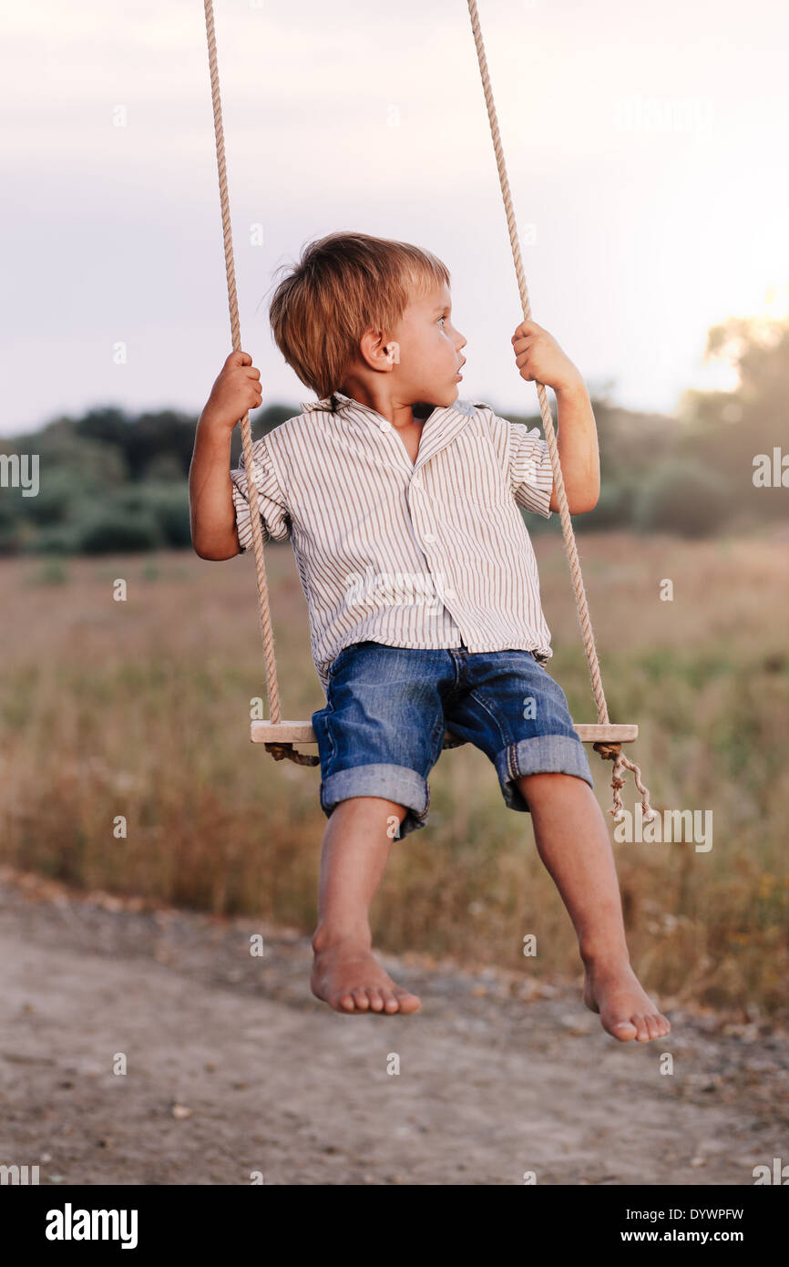 Child swinging tree hi-res stock photography and images - Alamy