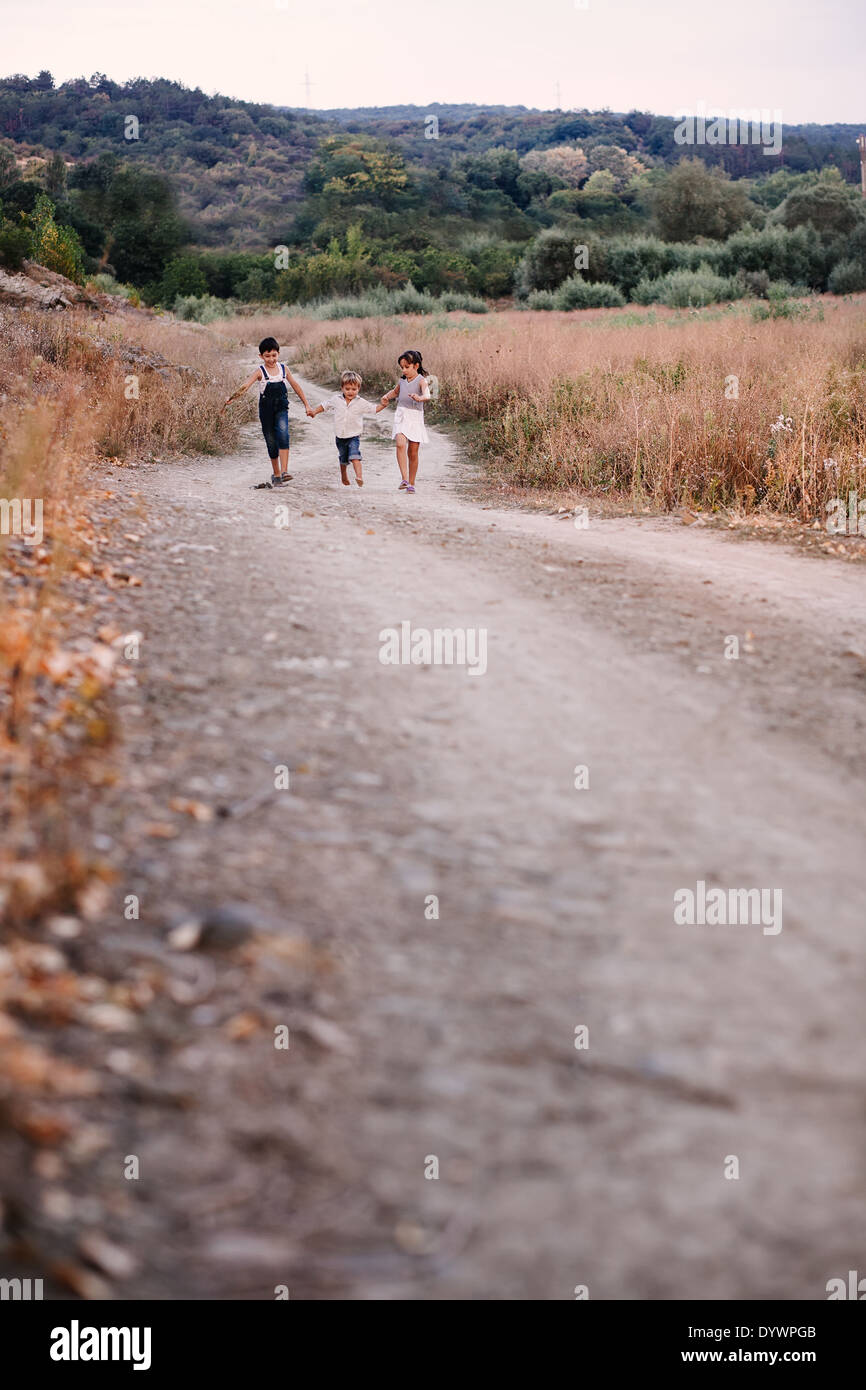 four children running outdoor Stock Photo - Alamy